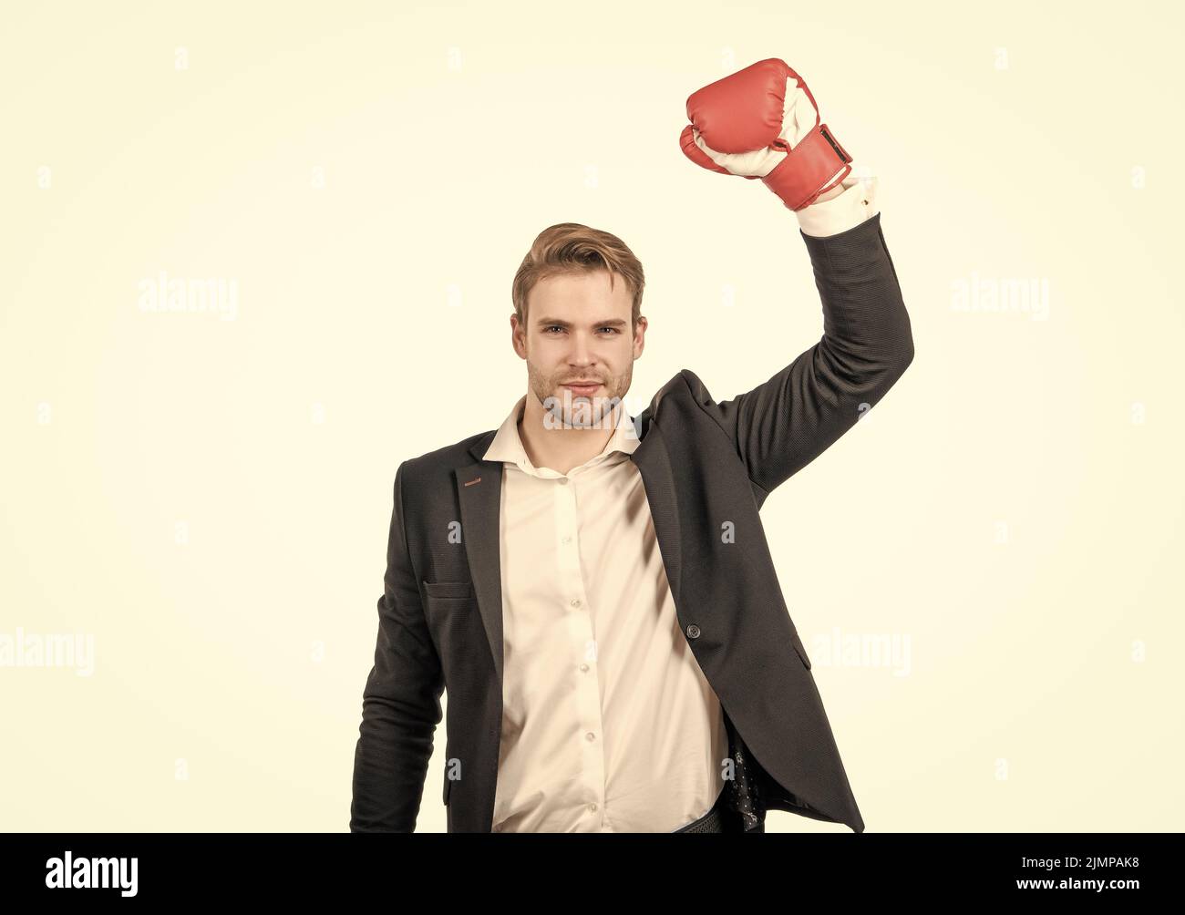 Professional man winner in formal suit with raised boxing glove ...