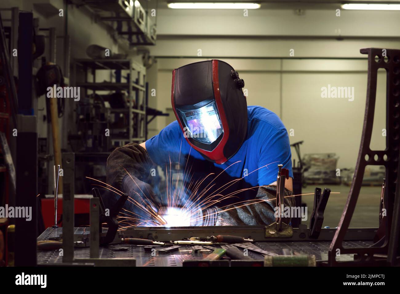 Professional Heavy Industry Welder Working Inside factory, Wears Helmet ...