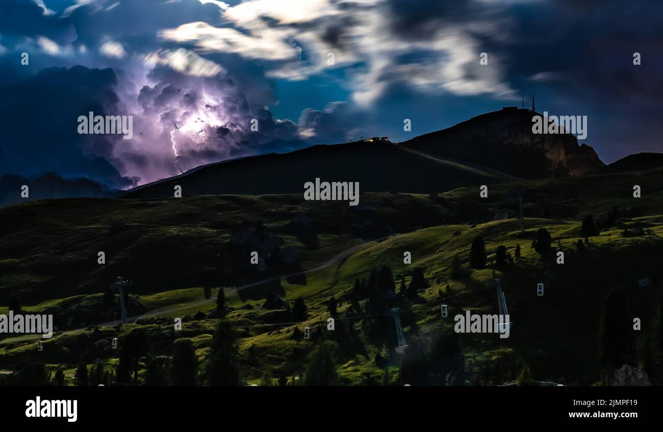 Lightning bolt hits during night thunderstorm in the Dolomites. Italy ...
