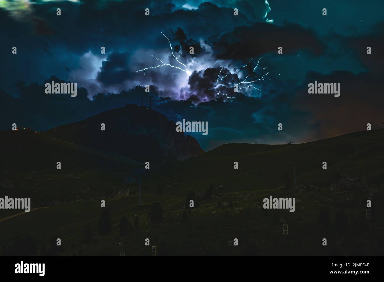 Huge lightning bolt during nightly thunderstorm in the Dolomites. Italy ...