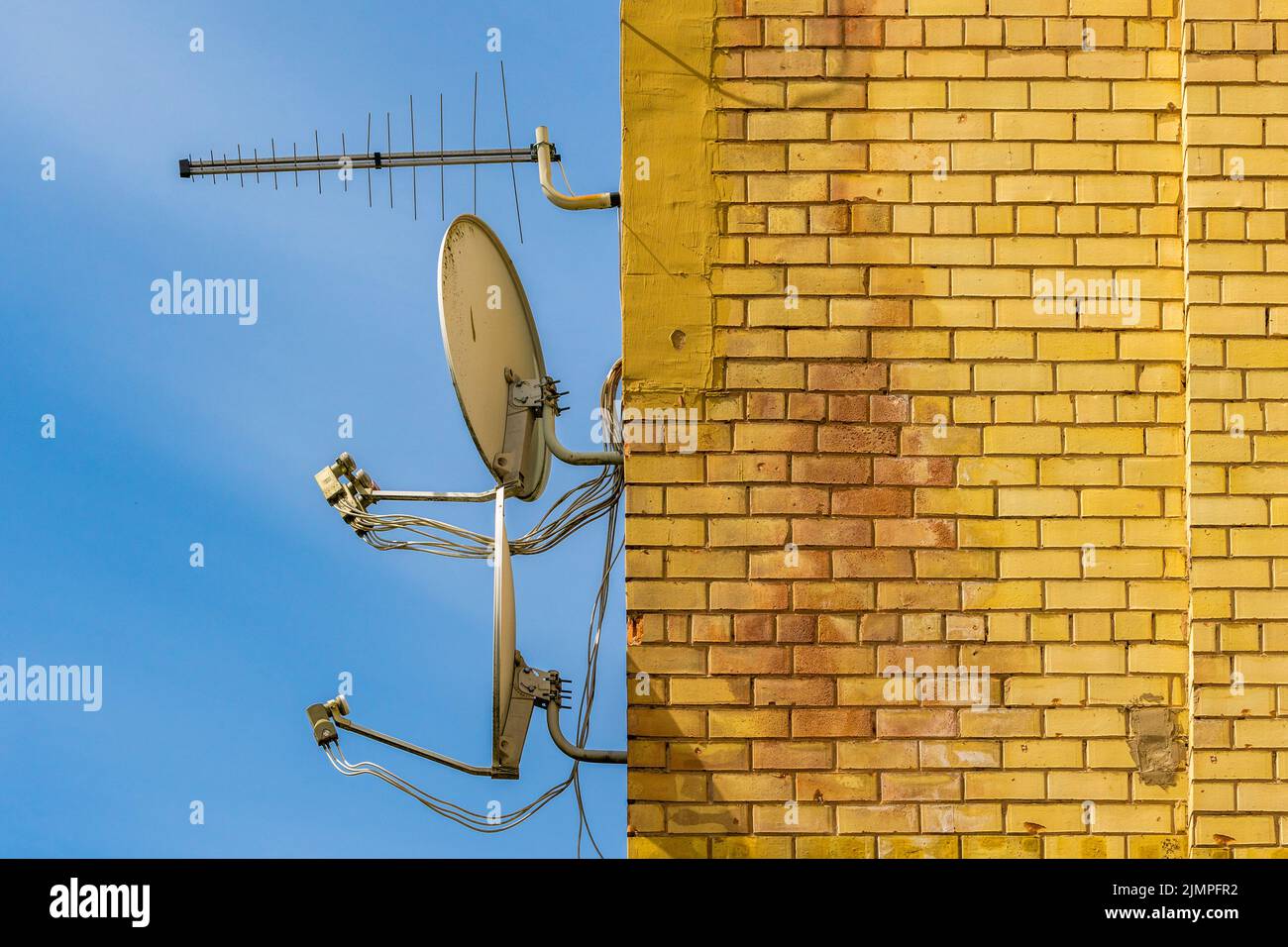 TV antennas attached to the wall of the house Stock Photo - Alamy
