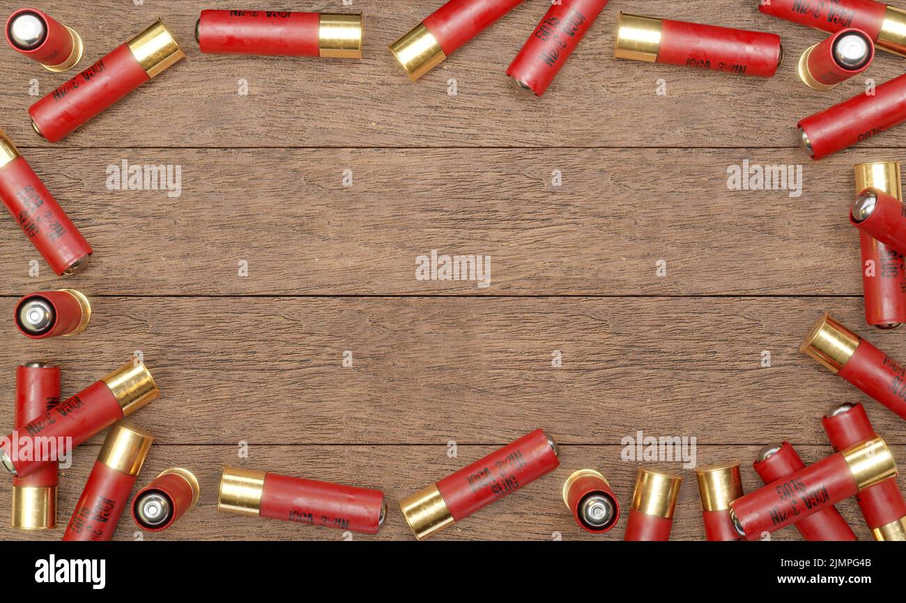 3d render illustration of a shotgun ammunition on wooden background ...