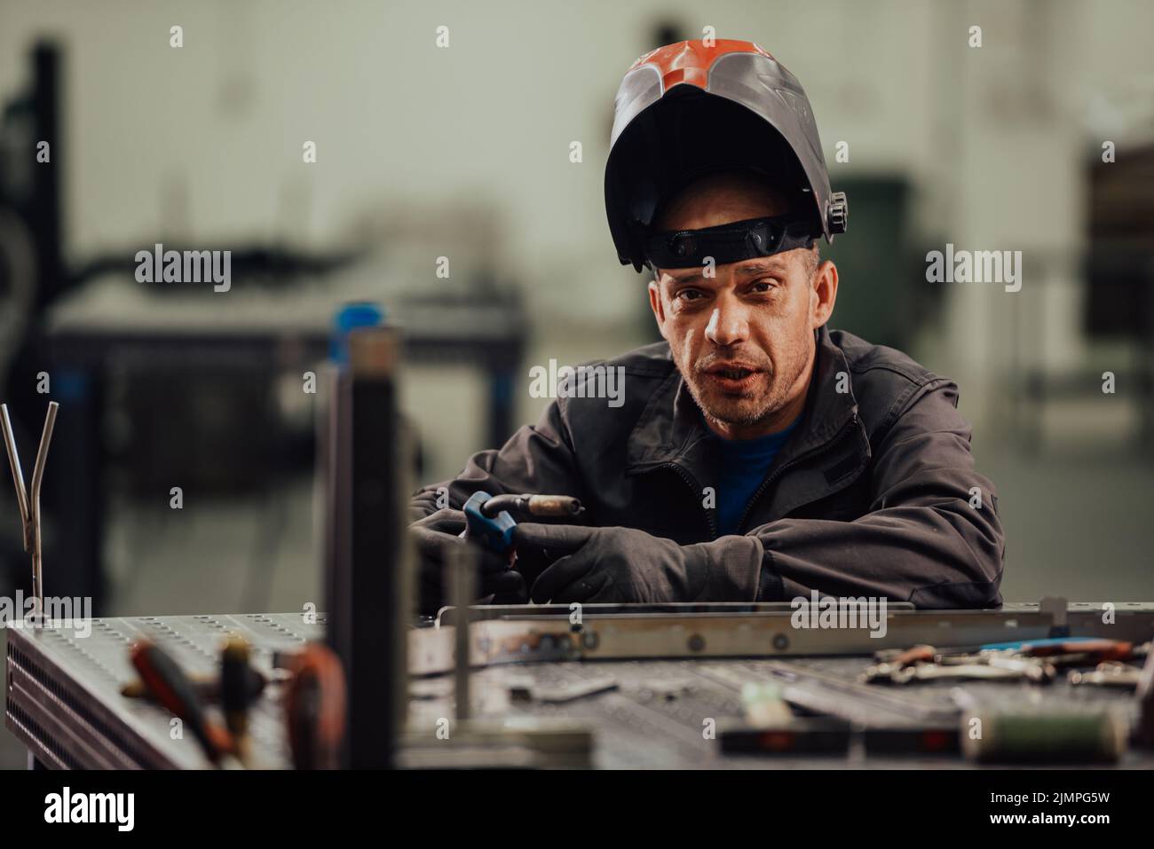 Professional Heavy Industry Welder Working Inside factory, Wears Helmet ...