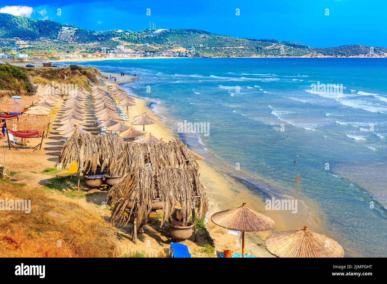 Sarti, Greece beach background with sea waves and umbrellas Stock Photo ...