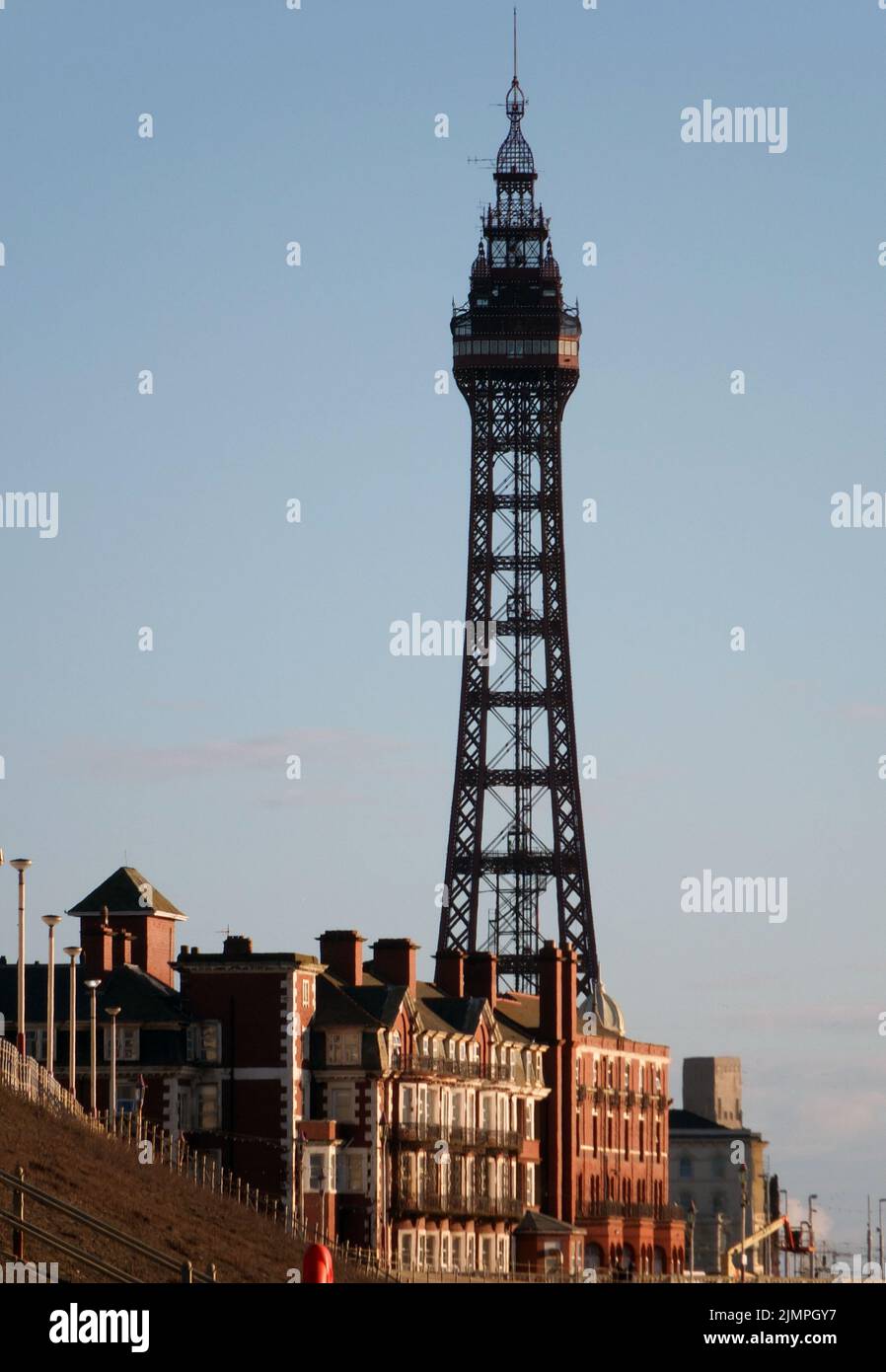 View of blackpool tower from the promenade with town buildings in ...
