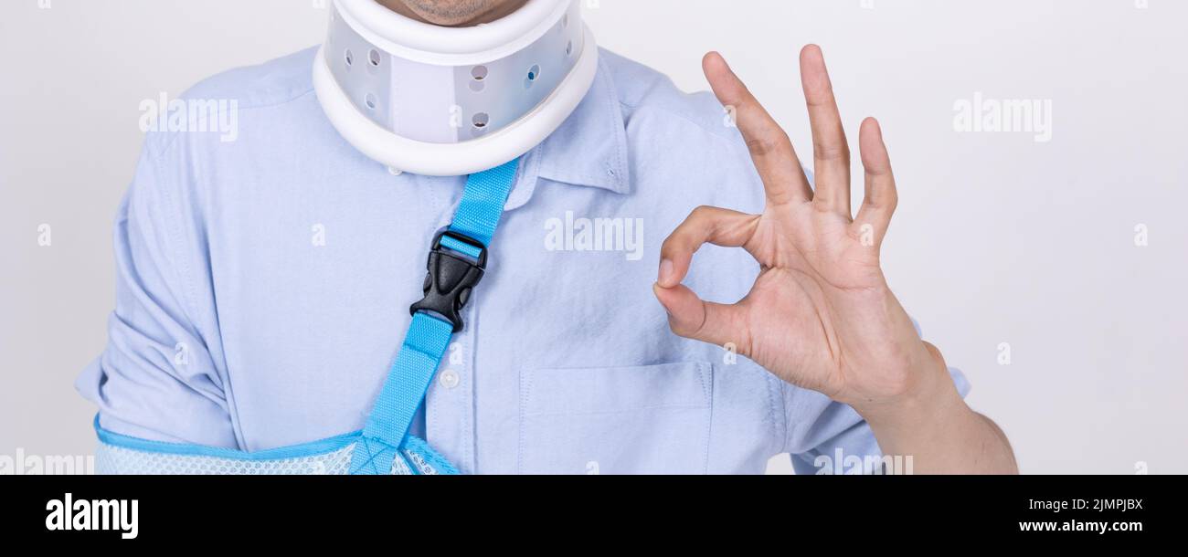Portrait of Asian man with broken arm and neck feeling showing okay ...