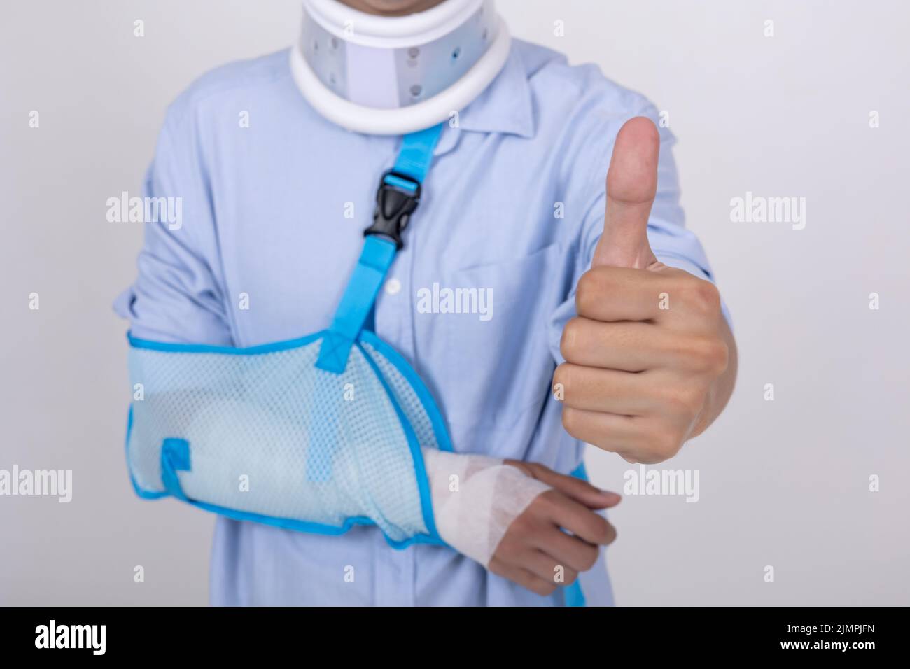 Portrait of Asian man with broken arm and neck feeling showing thumbs ...