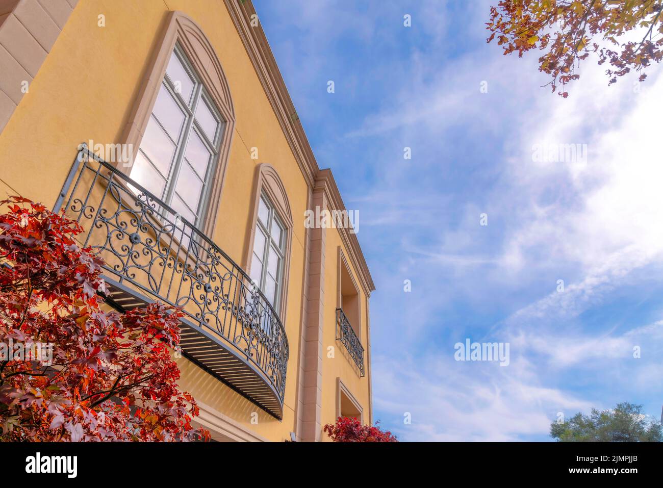 Slanted low angle view of a house with yellow walls and metal window ...