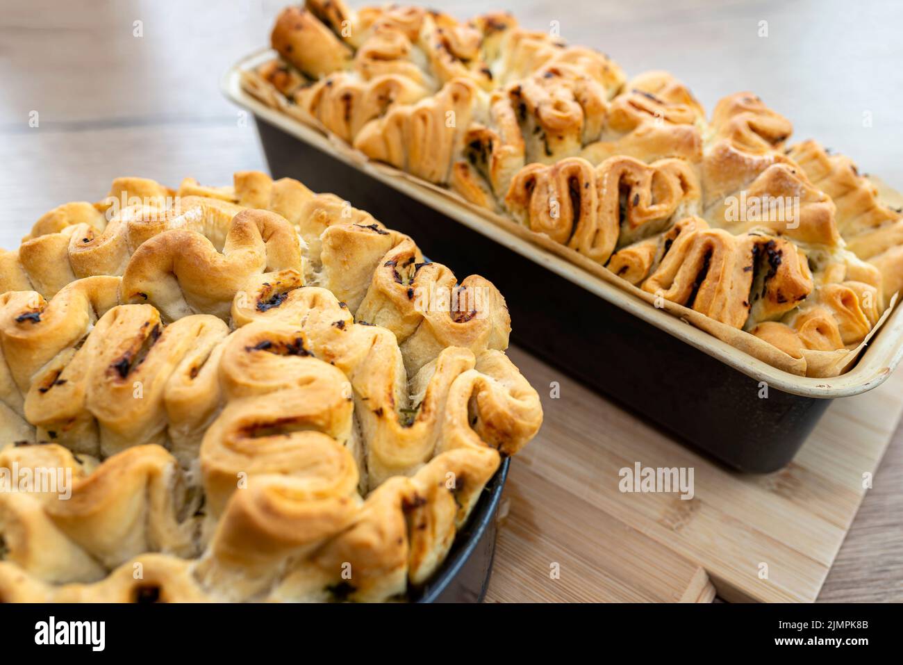 Homemade rectangular and round bread with garlic butter and herbs, in a ...