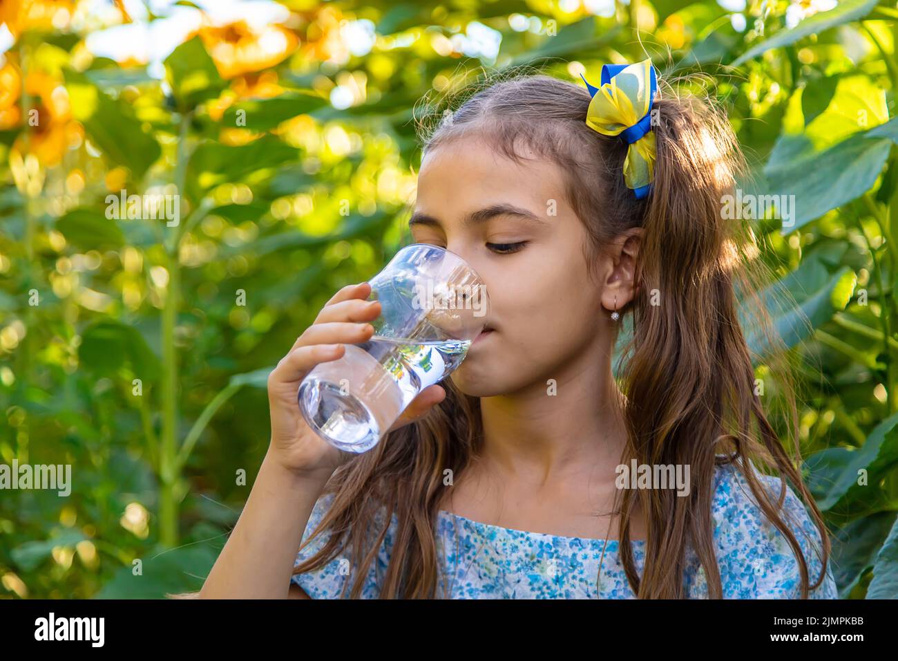 The child drinks water from a glass. Selective focus. Kid Stock Photo - Alamy