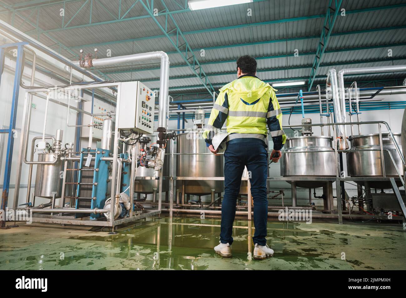 Rear of commitment caucasian technician engineer man in safety uniform ...