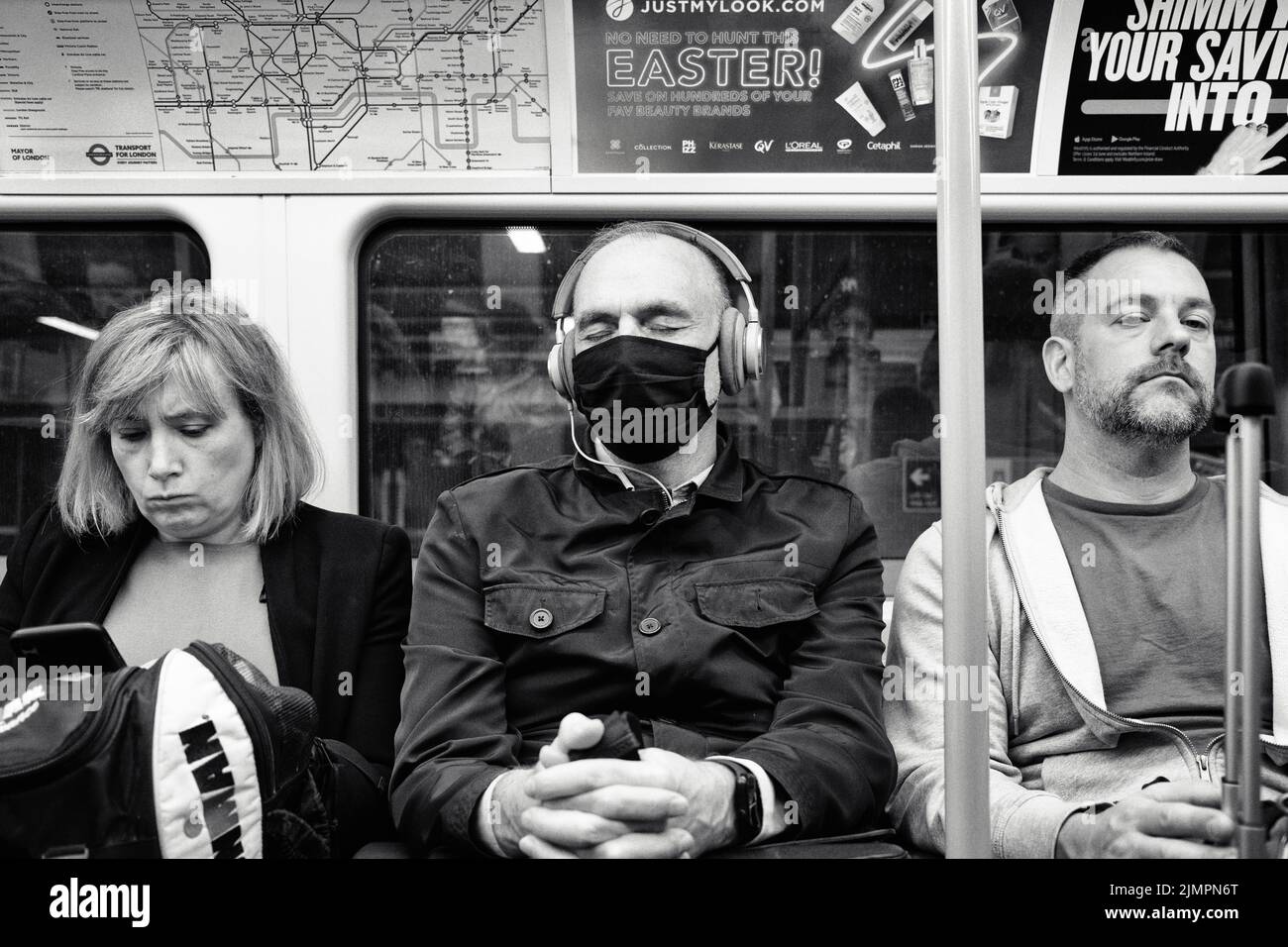 Transport for London; Tube; Tired and Masked Commuter Stock Photo - Alamy