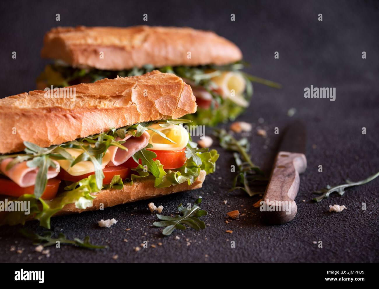 Baguette sandwich with cheese, ham, tomatoes and vegetables Stock Photo ...