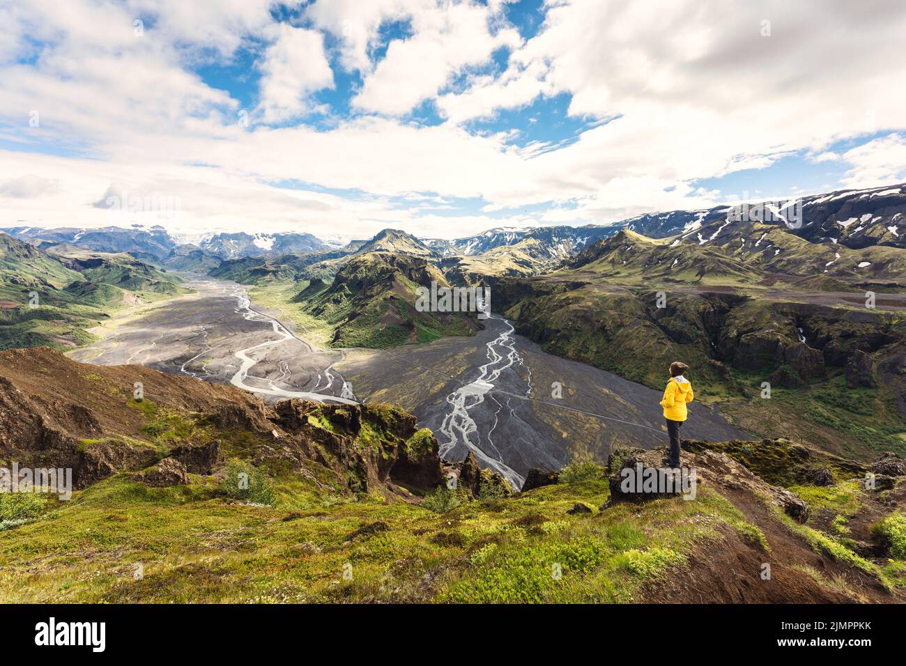 Scenery of Valahnúkur viewpoint with female hiker standing on peak and ...