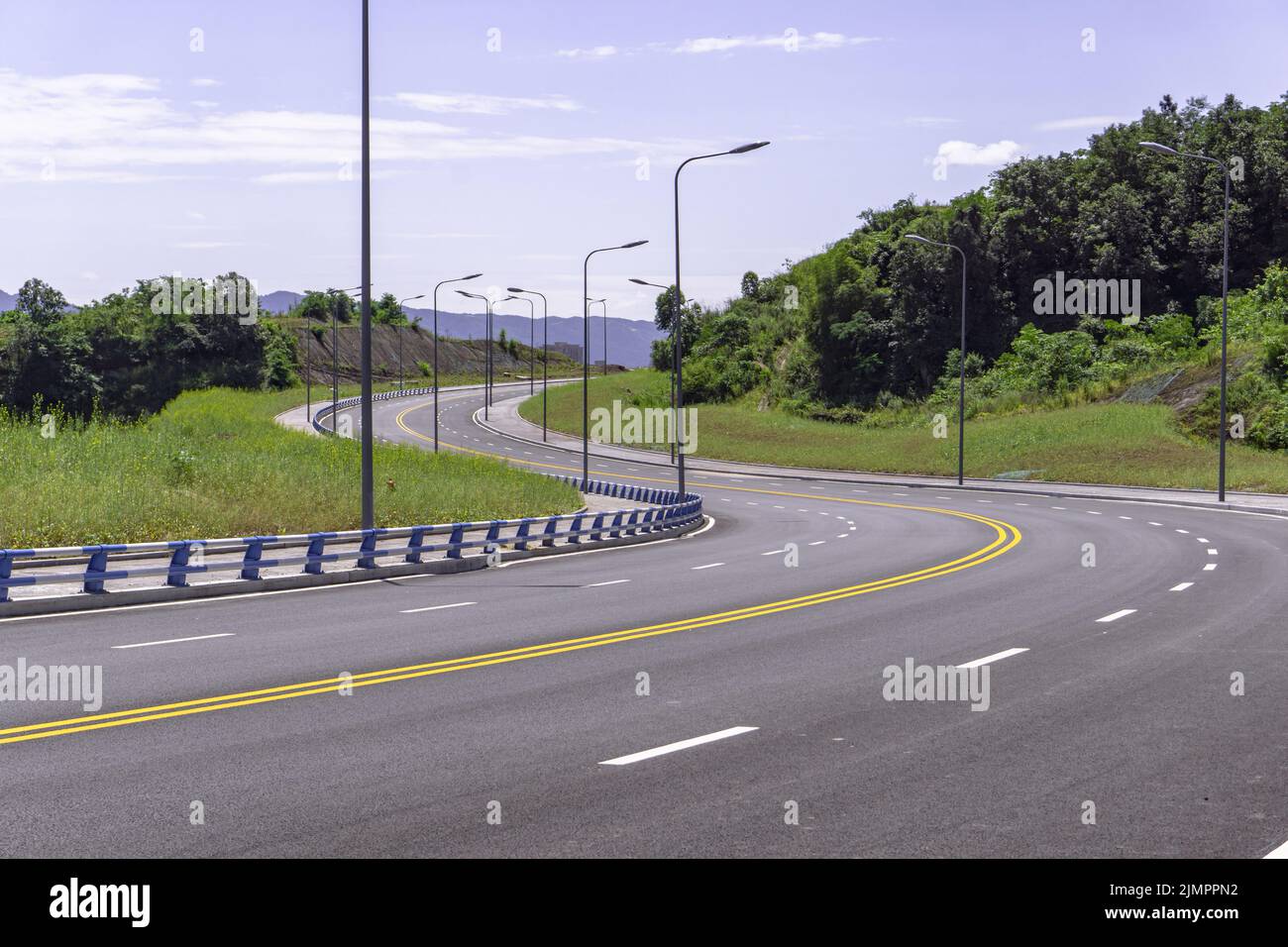 A highway road with vegetation on the sides during daytime Stock Photo ...
