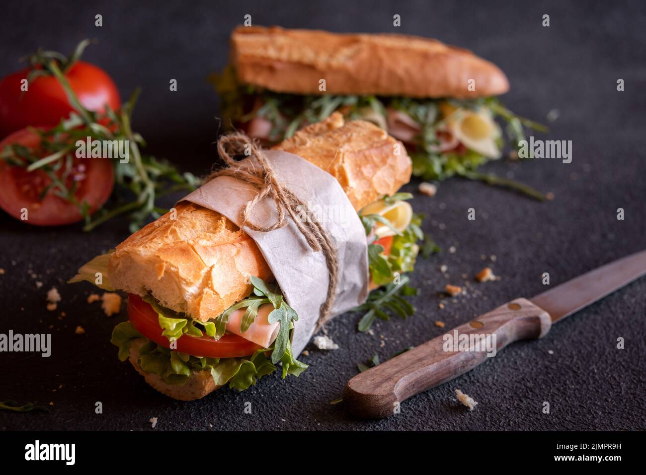 Baguette sandwich with cheese, ham, tomatoes and vegetables Stock Photo ...