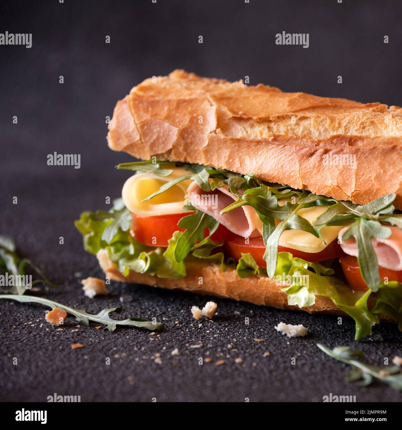 Baguette sandwich with cheese, ham, tomatoes and vegetables Stock Photo ...