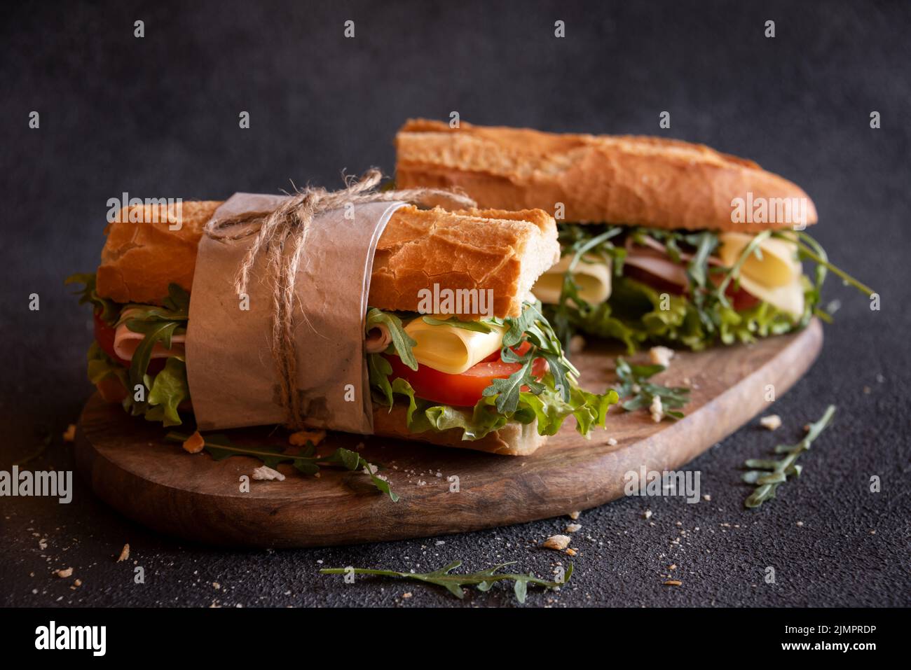 Baguette sandwich with cheese, ham, tomatoes and vegetables Stock Photo ...