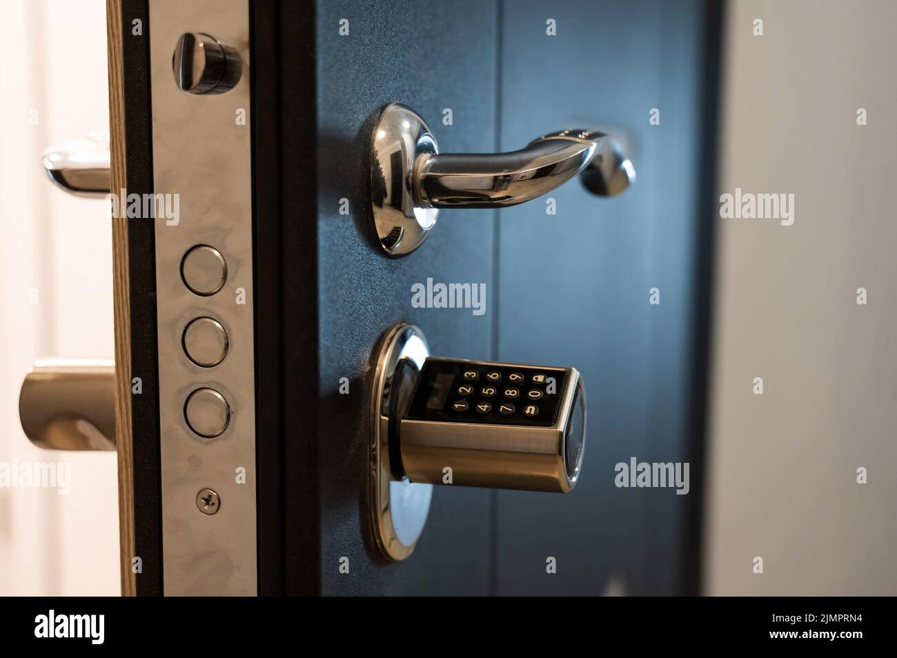 Open door to the apartment with a combination lock. Keyless entry Stock ...