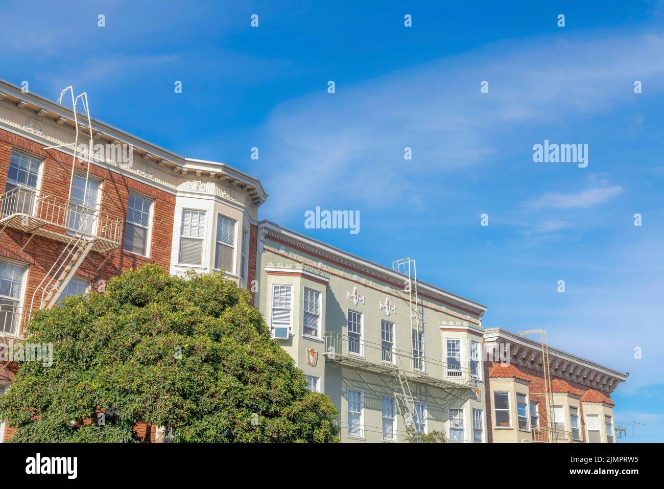 Apartment buildings with emergency staircase exit outside against the ...