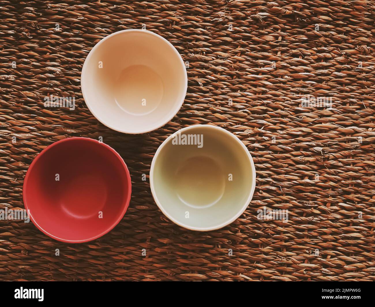 Small empty ceramic measure bowls on rustic wicker background, food ...