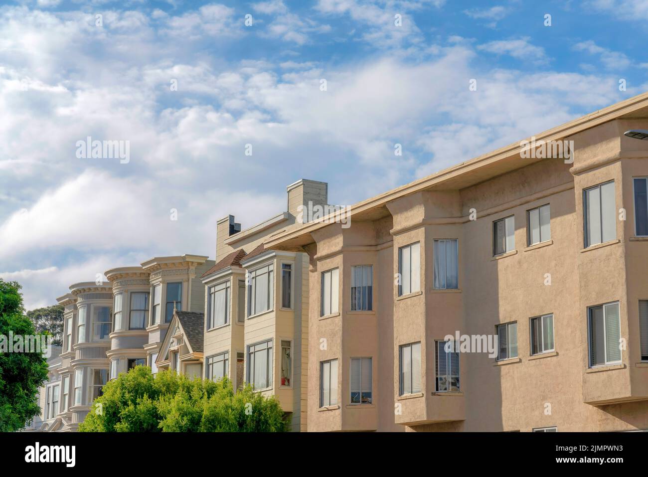 Residential buildings in a row with trees at the front in San Francisco ...