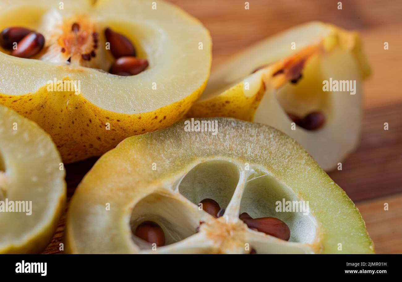 Japanese quince fruit, Chaenomeles Lindl. Close-up of ripe, sliced ...