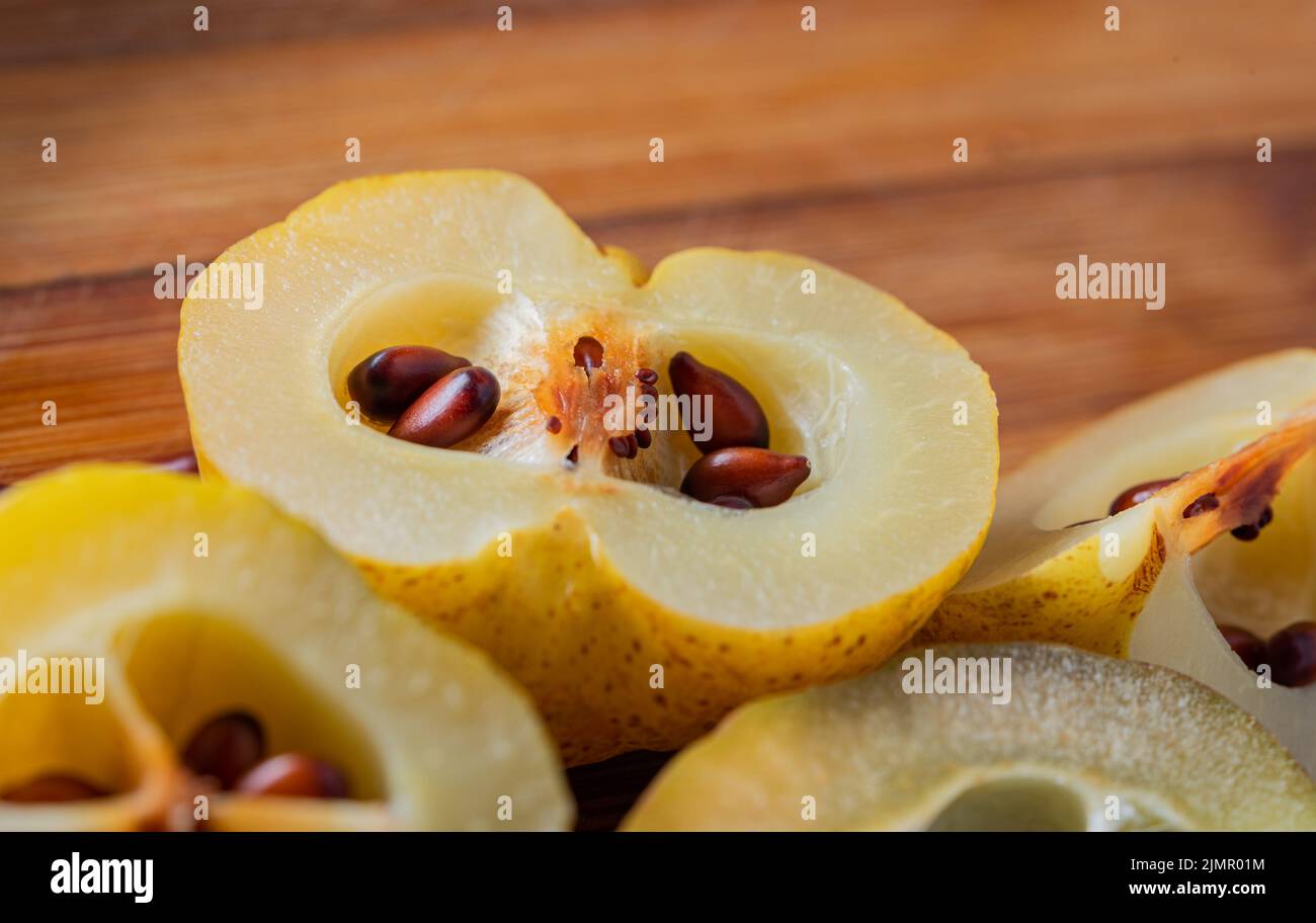 Japanese quince fruit, Chaenomeles Lindl. Close-up of ripe, sliced ...