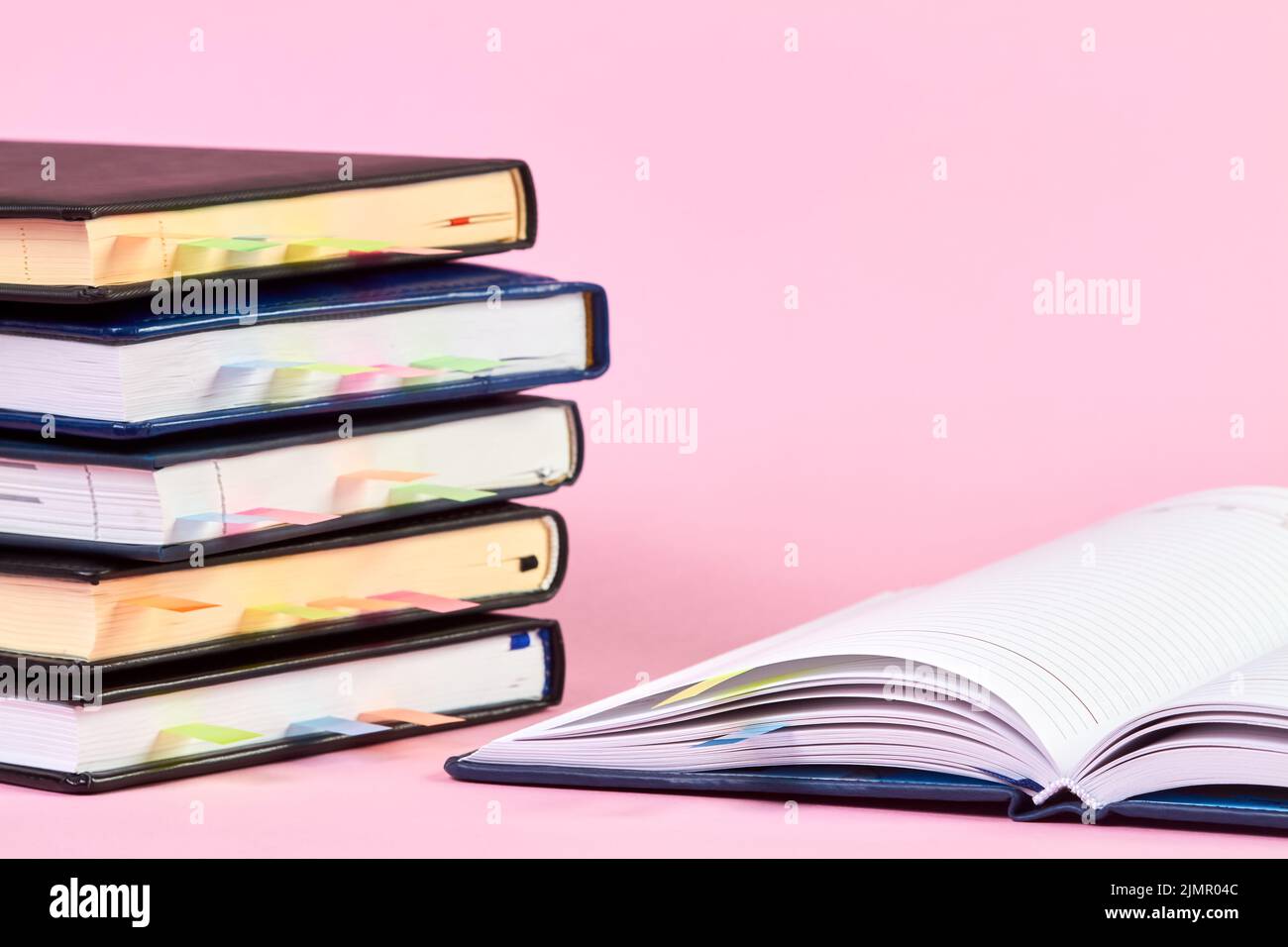 Close-up of an open notepad with colorful sticky page markers on ...