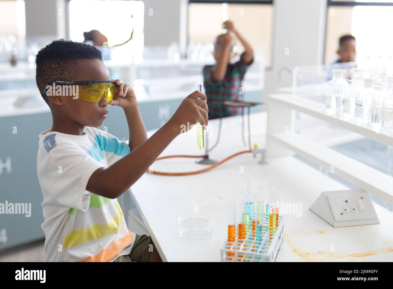 African american elementary schoolboy performing chemical experiment ...