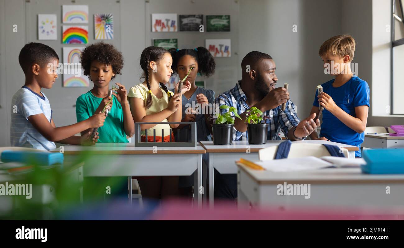 Multiracial elementary students and african american young male teacher ...