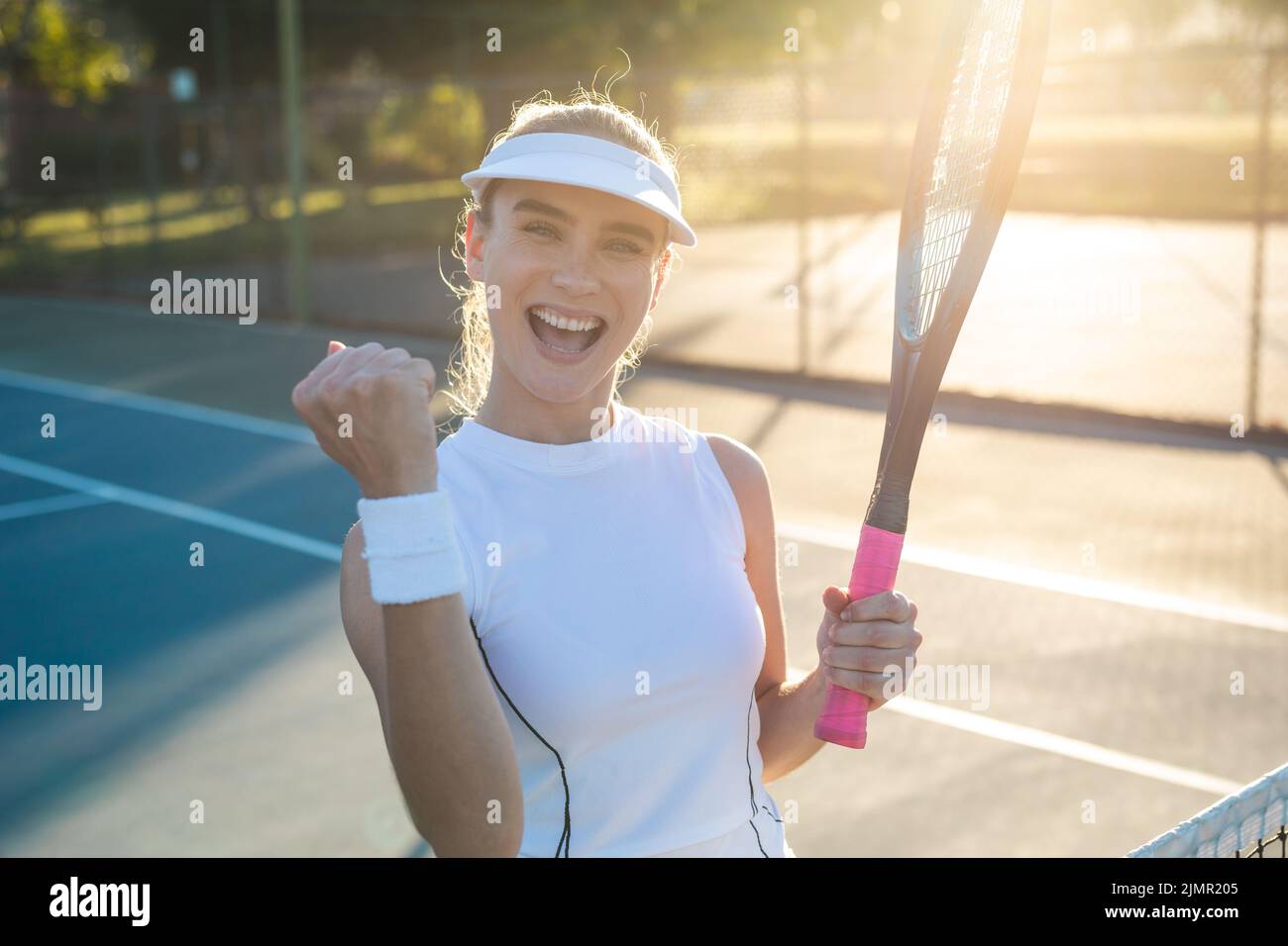Portrait of happy young beautiful caucasian female player celebrating ...