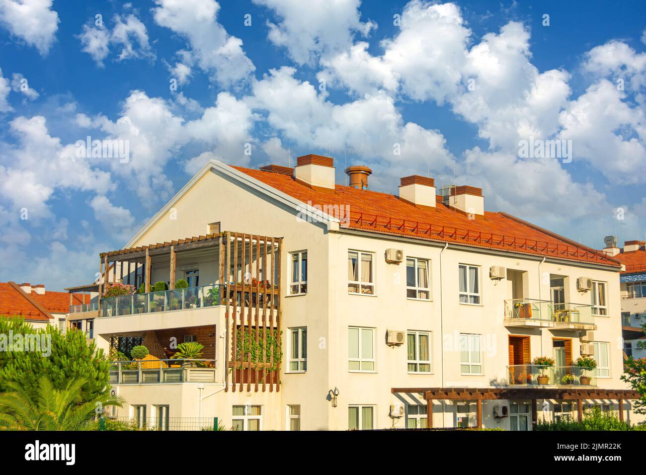 Residential house with tiled roof and large terraces with wooden ...
