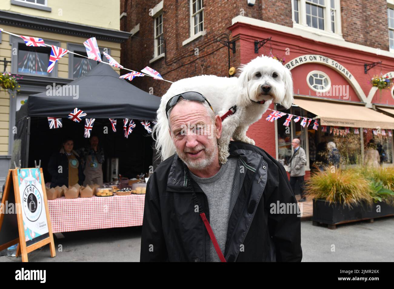 Man walking with his pet dog on his shoulders in Britain 2022 Stock Photo - Alamy