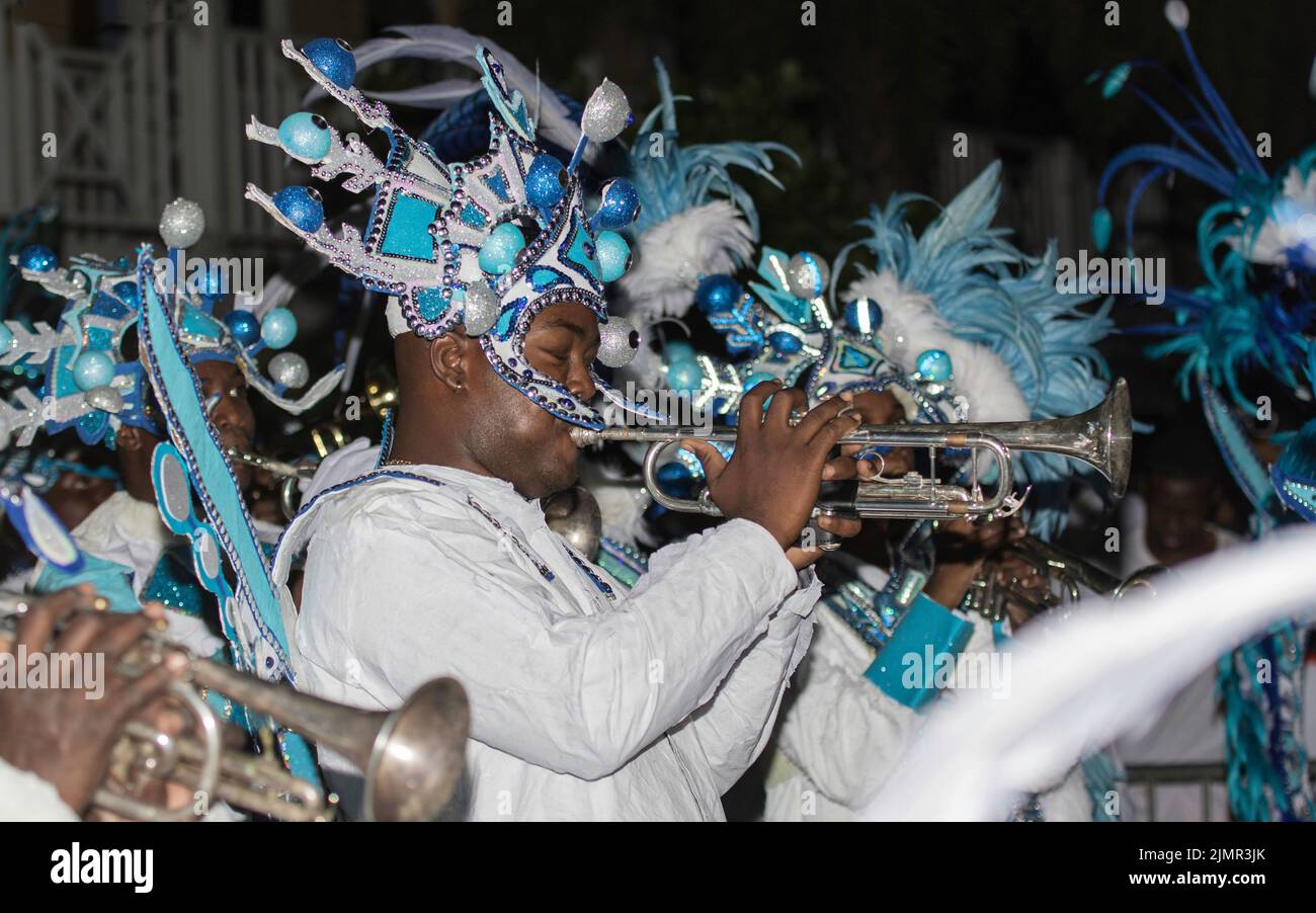 Men beating drums and blowing trumpets in colorful costumes for ...