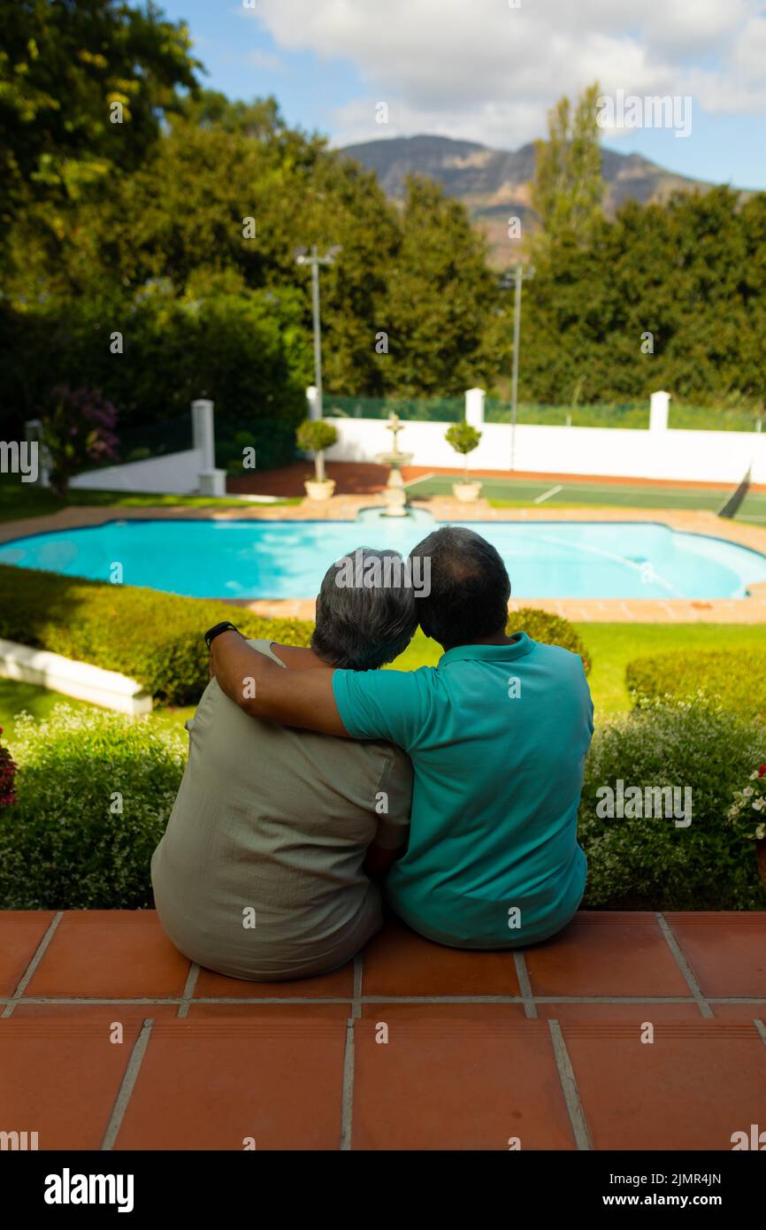 Rear View Of Biracial Senior Man With Hand On Wifes Shoulder Looking