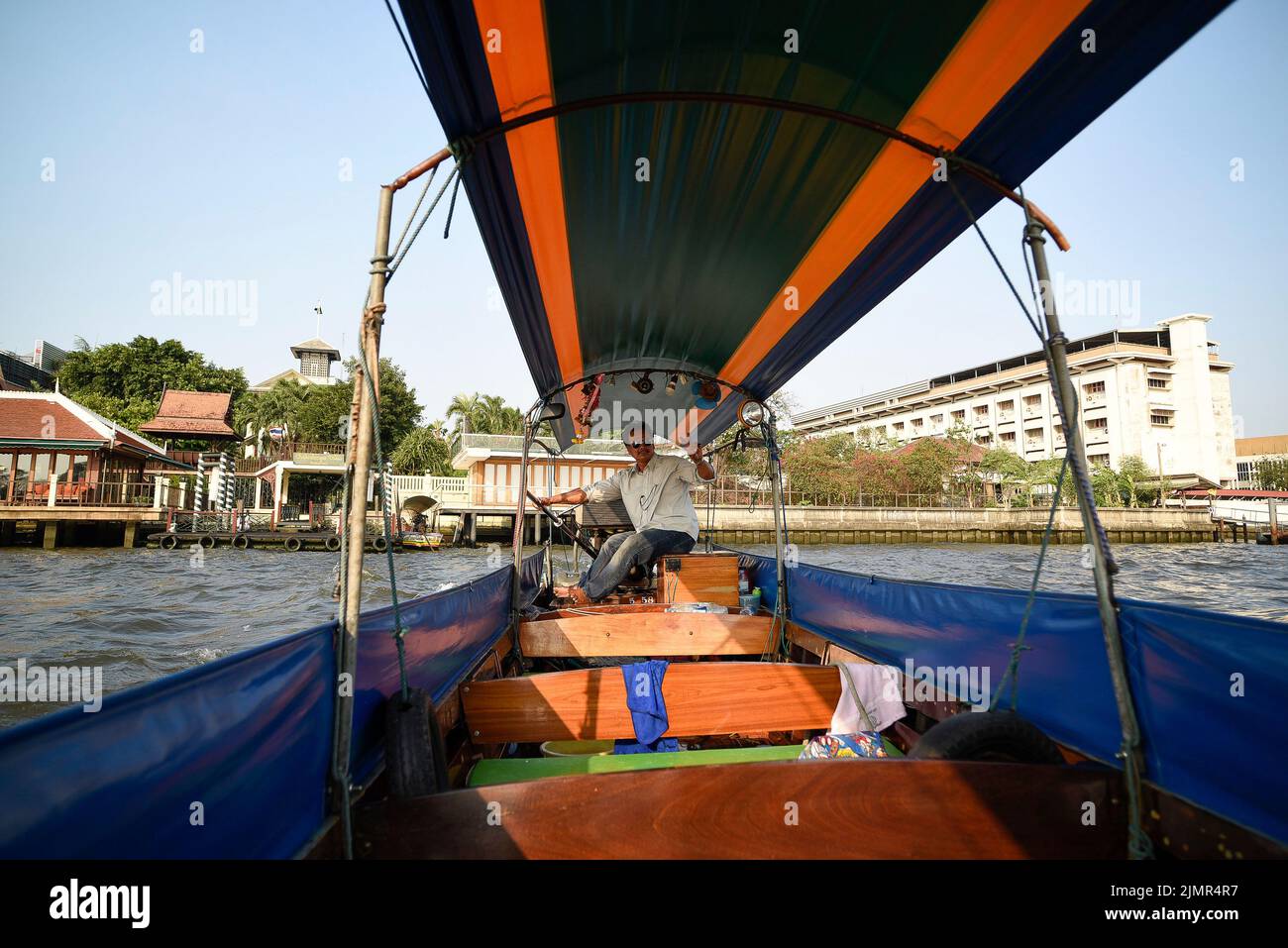 Chao Phraya River Canal Cruise boat and captain. Traditional canal tour ...