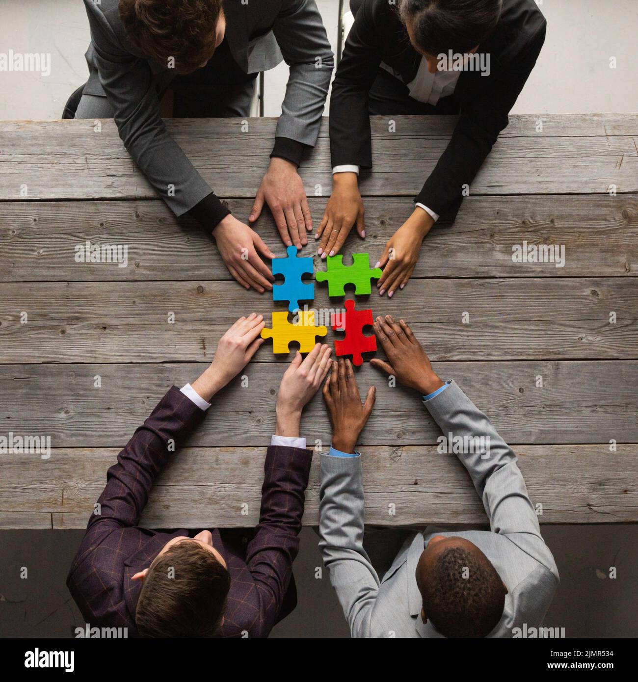 Diverse team people assembling jigsaw puzzle, multiracial group of ...