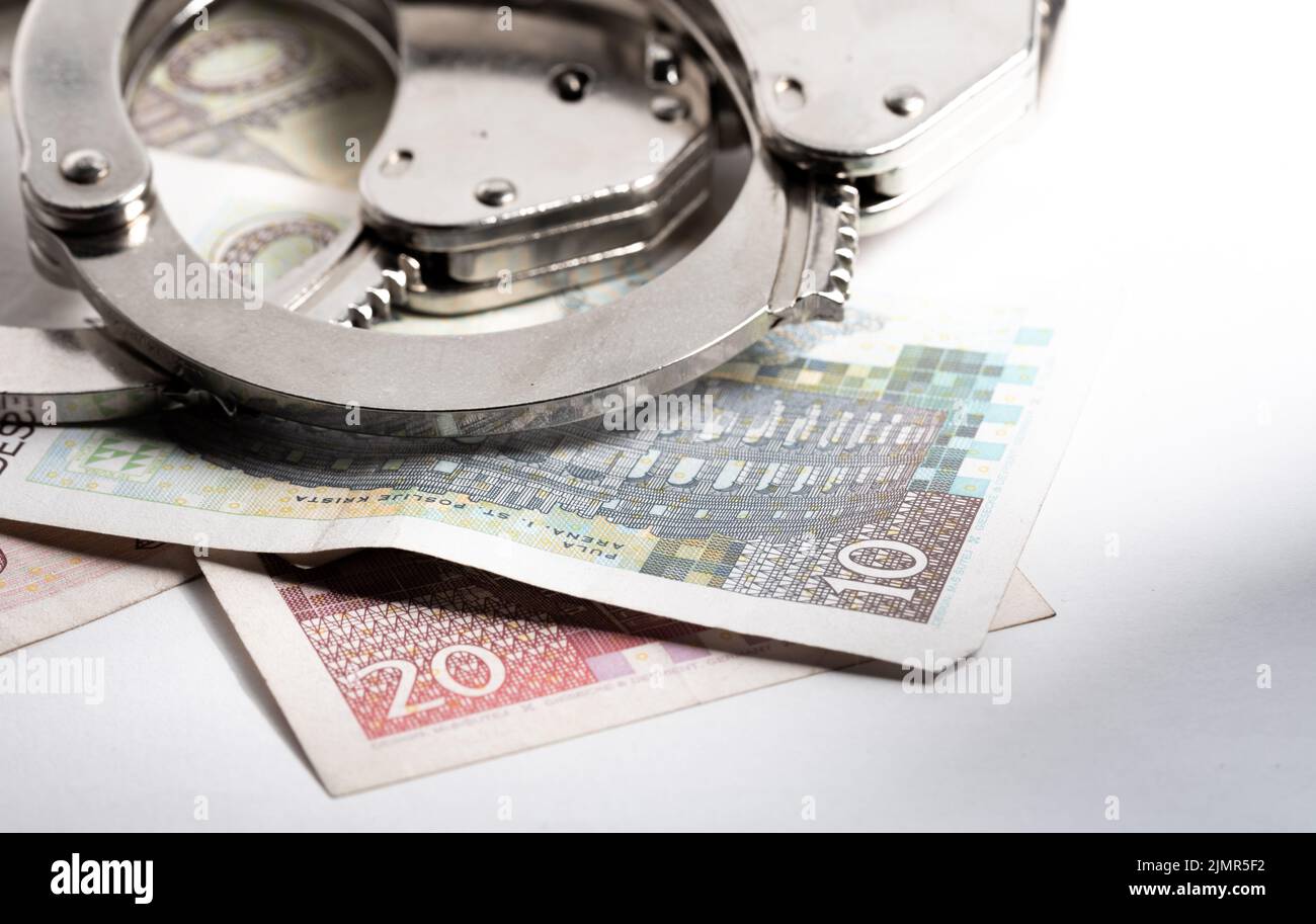 Croatian kuna currency. Police handcuffs on Croatian kuna banknotes ...