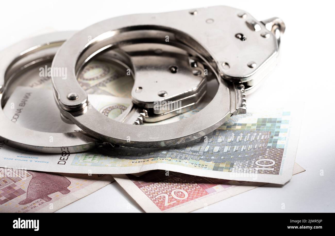 Croatian kuna currency. Police handcuffs on Croatian kuna banknotes ...