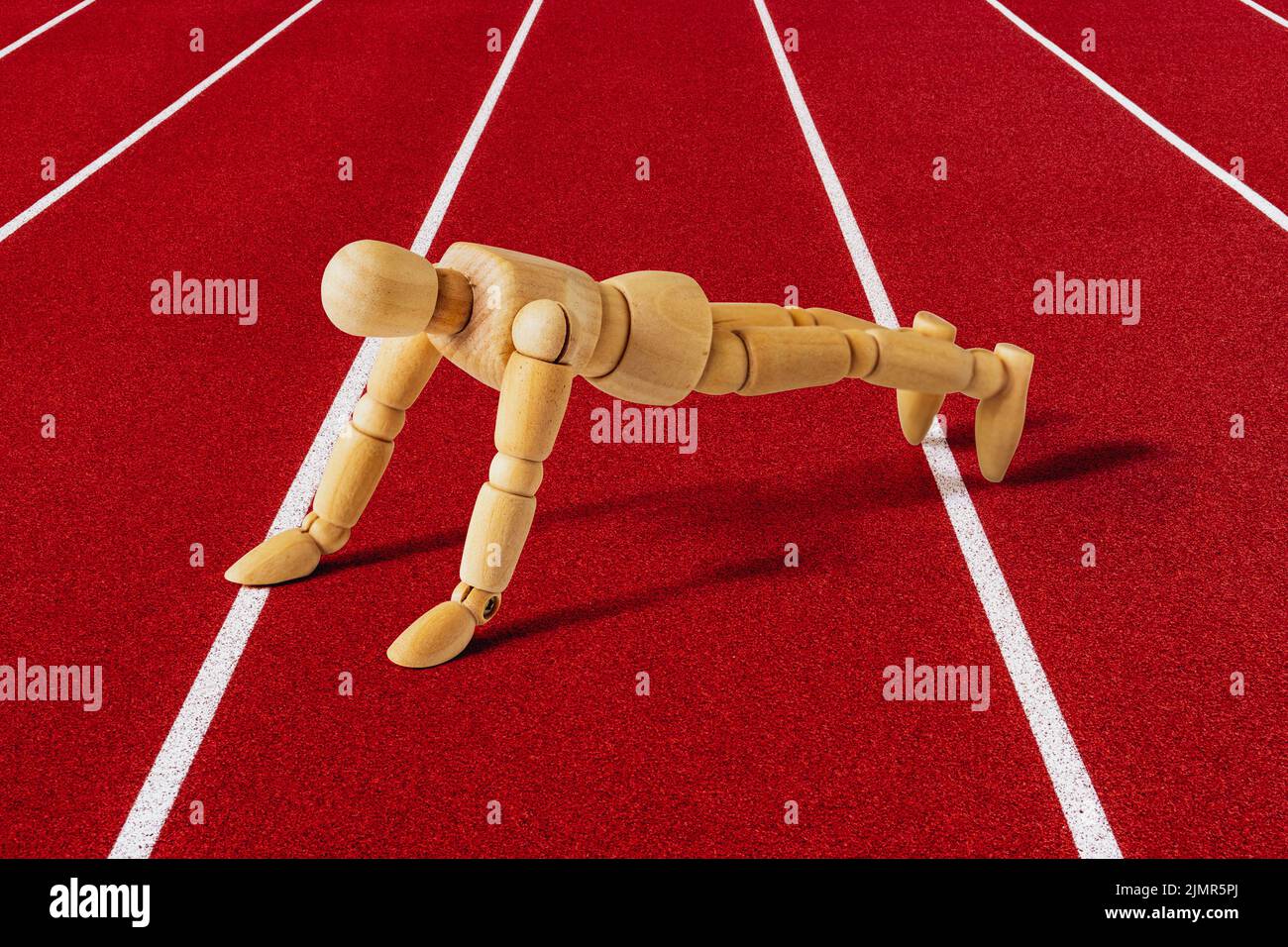 Wooden sportsman doing push ups on running track Stock Photo - Alamy