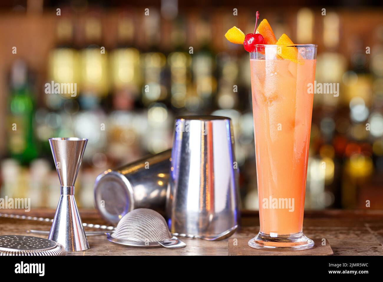 Working tool of the bartender and a prepared cocktail on the bar in the ...