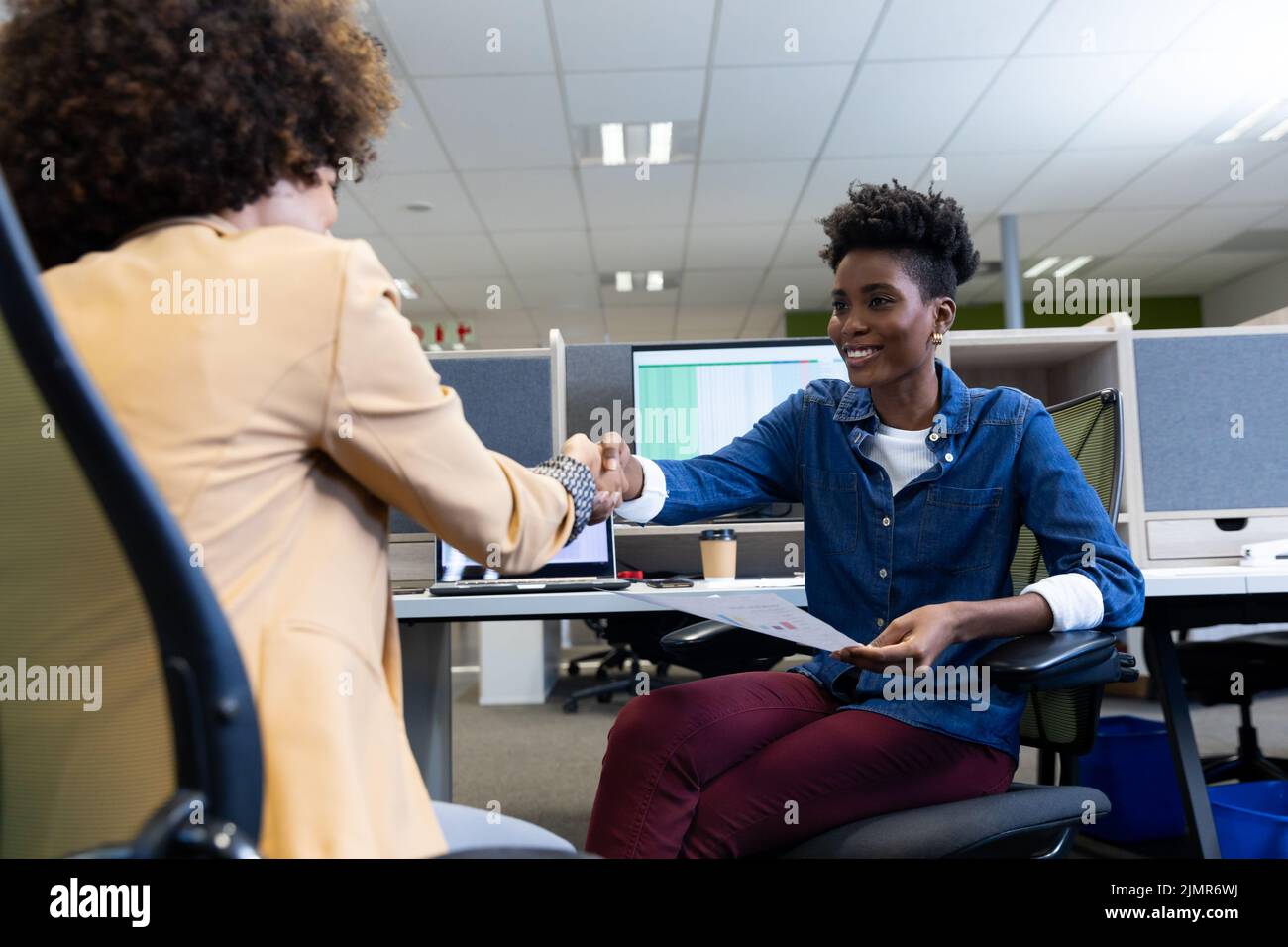 Smiling african american businesswoman shaking hands with hispanic ...