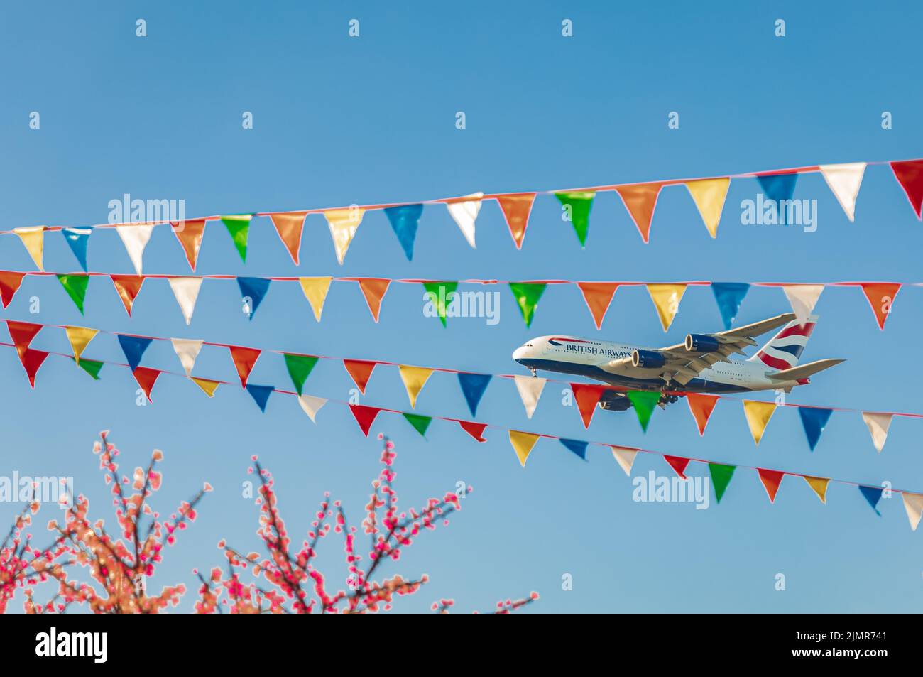 Party flags colorful celebrate and British Airways plane flying on blue ...