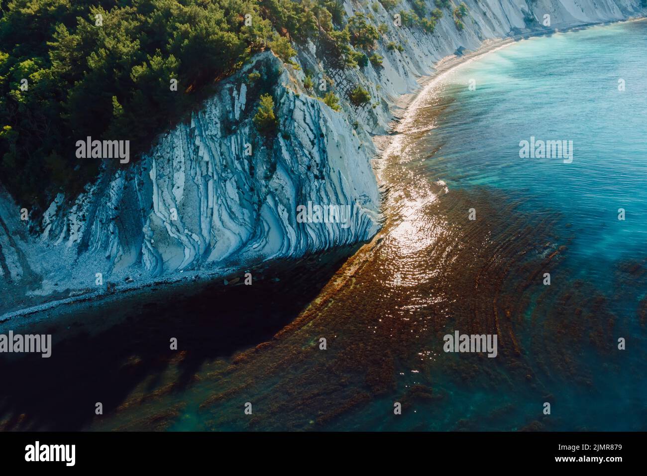 Aerial view of scenic coastline with blue sea and cliffs with pine ...