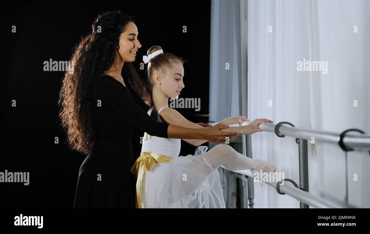 Teen girl child teenager ballerina in tutu has advice of woman coach ...