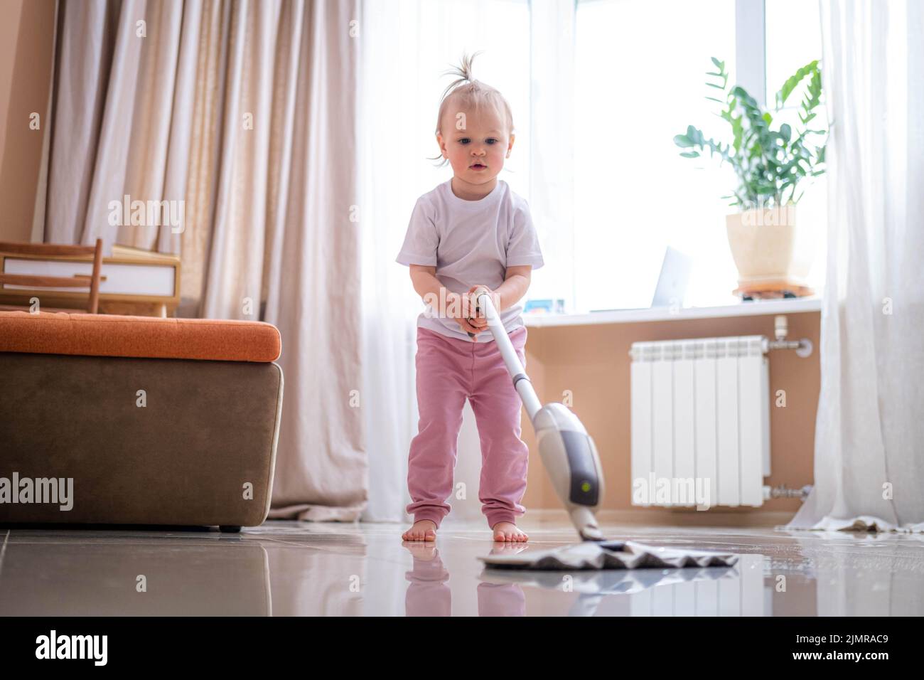 little daughter cleaning in the house, child dusting, Cute little ...