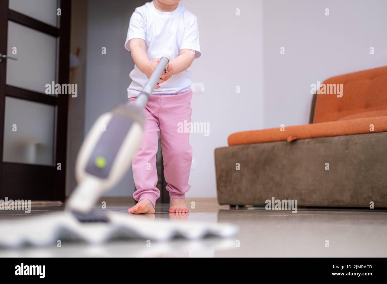 little daughter cleaning in the house, child dusting, Cute little ...