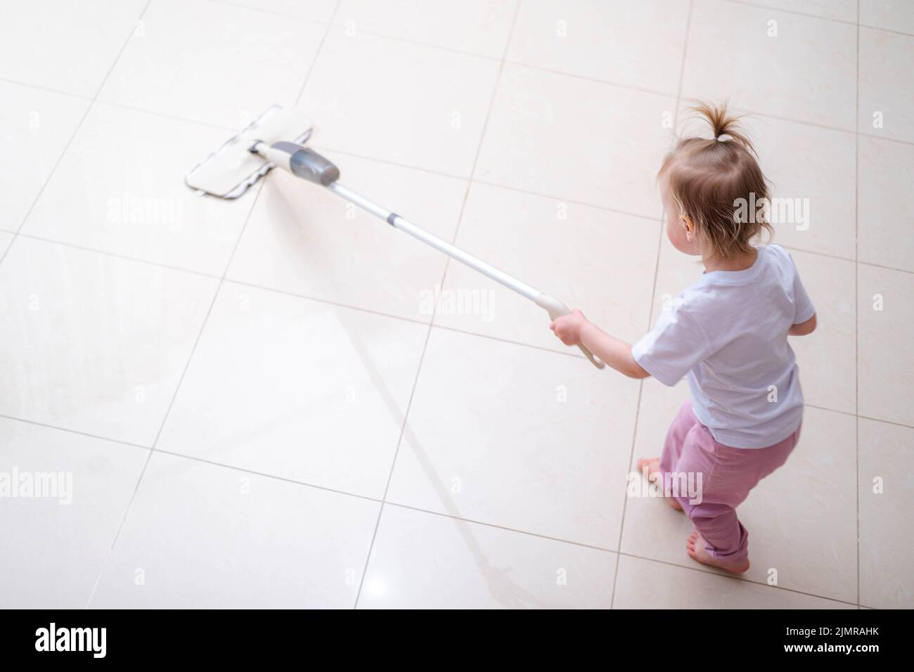 little daughter cleaning in the house, child dusting, Cute little ...
