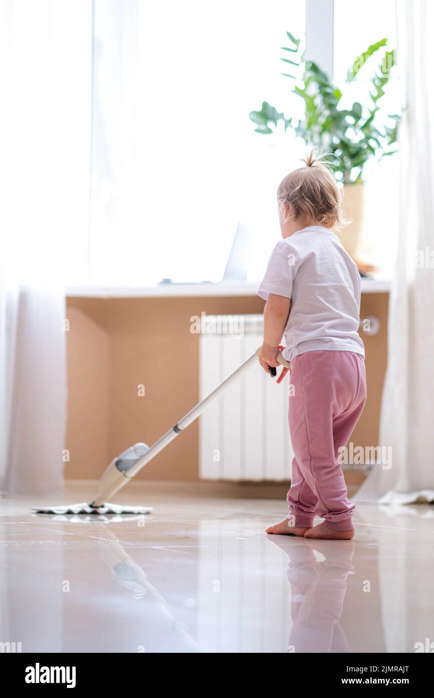 little daughter cleaning in the house, child dusting, Cute little ...